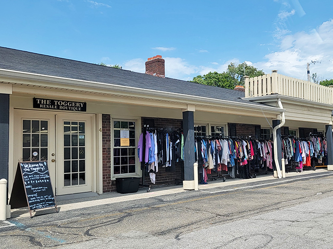 Clothing racks peek through garage-style doors, inviting you to discover carefully curated treasures at unbelievable thrift prices.