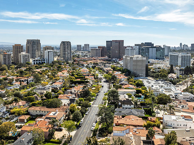 Tree-lined residential streets create a perfect patchwork of suburban life beneath those impressive high-rise buildings.