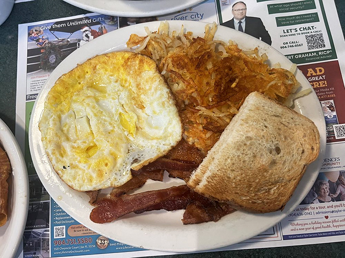 The classic two-egg breakfast—proof that simplicity, when executed perfectly, is the ultimate luxury. Those hashbrowns are calling my name.