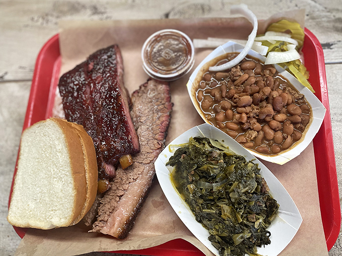 The Texas trinity plate: brisket with that telltale pink smoke ring, beans simmered to perfection, and greens that have found their purpose in life.