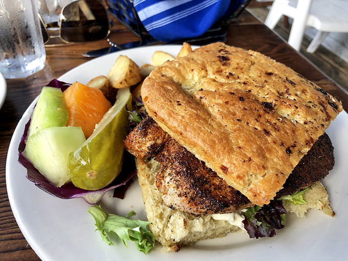 The Ahi sandwich—where the fish is the star and the bread is just there to keep your fingers clean. Those pickles deserve their own fan club.