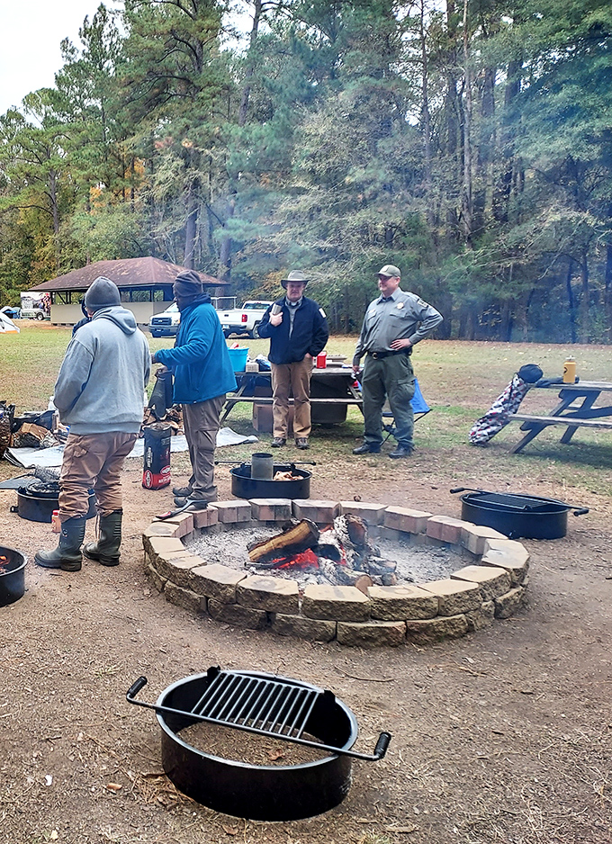 Campfire camaraderie in action. Nothing brings strangers together like a well-built fire ring and the universal language of outdoor cooking.