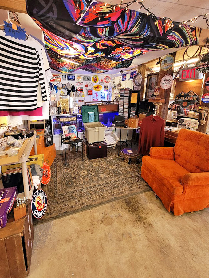 Psychedelic fabric drapes from the ceiling while vintage signs and an orange couch create a time capsule you can actually sit in.