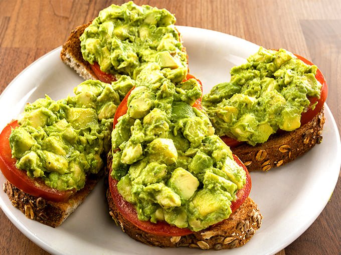 Avocado toast that Instagram dreams are made of. Chunky green goodness on hearty bread that would make millennials weep with joy.