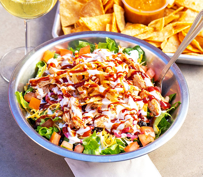 Fresh greens meet smoky proteins in this colorful symphony, proving barbecue joints can craft salads worthy of applause too.