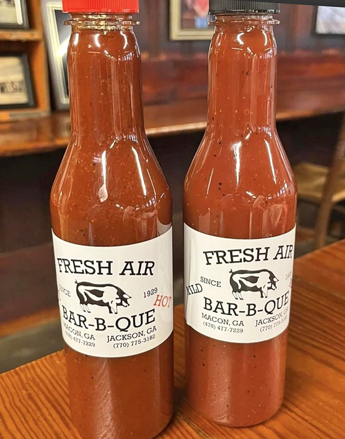 These bottles contain liquid gold – the house sauce that transforms good barbecue into a religious experience, available in mild or "Georgia summer" hot.