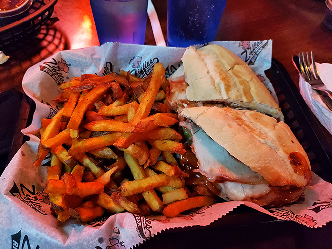The pulled pork sandwich sits proudly next to a mountain of fries, like the king and queen of comfort food holding court on wax paper.