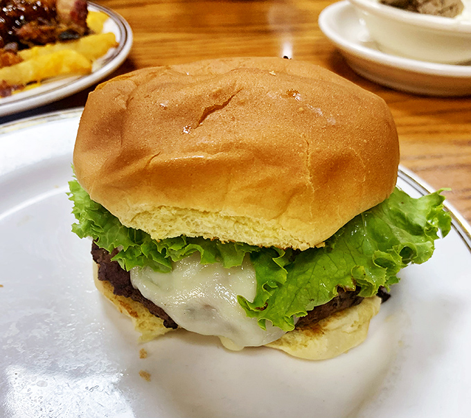 A burger that requires both hands and several napkins&mdash;melted cheese draping over the patty like it's getting comfortable for a long stay.
