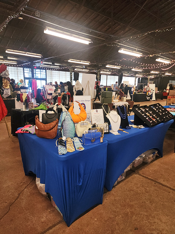 A blue-draped vendor table showcasing handbags and jewelry &ndash; retail therapy stations strategically positioned for maximum "I deserve this" justification.
