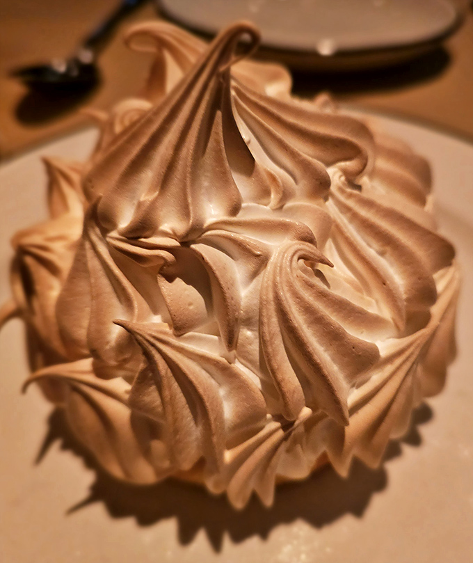 The Baked Alaska's perfectly toasted meringue peaks look like they're auditioning for a role in a dessert beauty pageant.