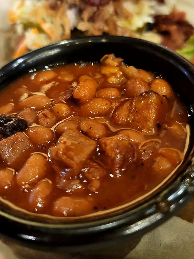 Baked beans swimming in a molasses-rich sauce that's absorbed all the smoky wisdom from bits of meat. Spoonful archaeology at its finest.
