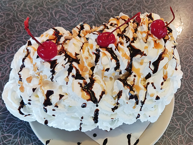 A mountain range of whipped cream with chocolate and caramel rivers flowing freely—this banana split has its own ecosystem.