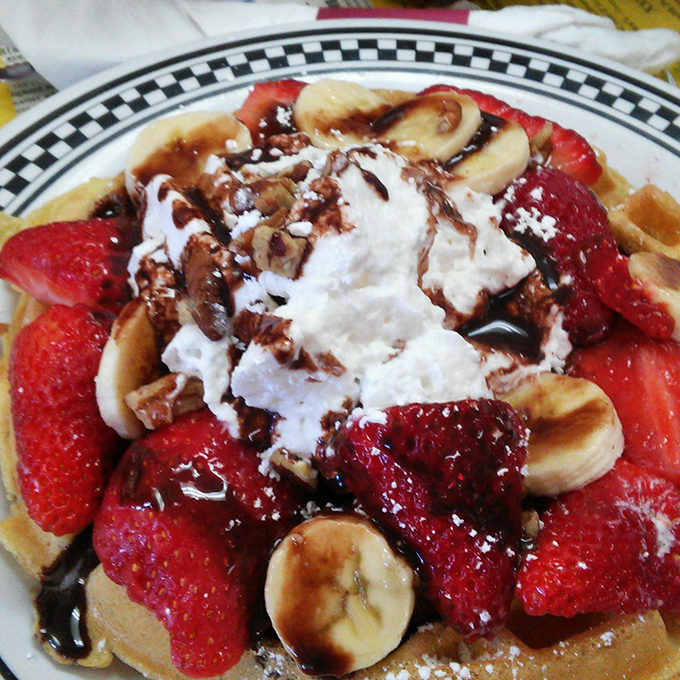 Waffles living their best life, adorned with fresh strawberries and bananas. Breakfast masquerading as dessert &ndash; the ultimate morning hustle.