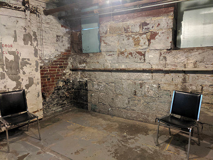 Basement accommodations at the jail make today's studio apartments look positively palatial. Two chairs facing a crumbling wall&mdash;the original timeout corner.