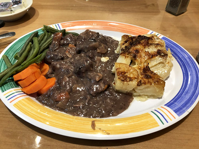 Beef tips in rich gravy alongside fresh vegetables and golden potatoes&mdash;proof that dinner at Country Boy isn't playing second fiddle to breakfast.