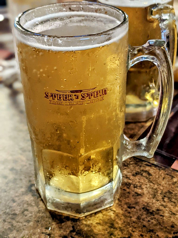 A frosty mug bearing the Steer N' Stein logo&mdash;because sometimes the perfect companion to a great steak is a cold beer in substantial glassware.