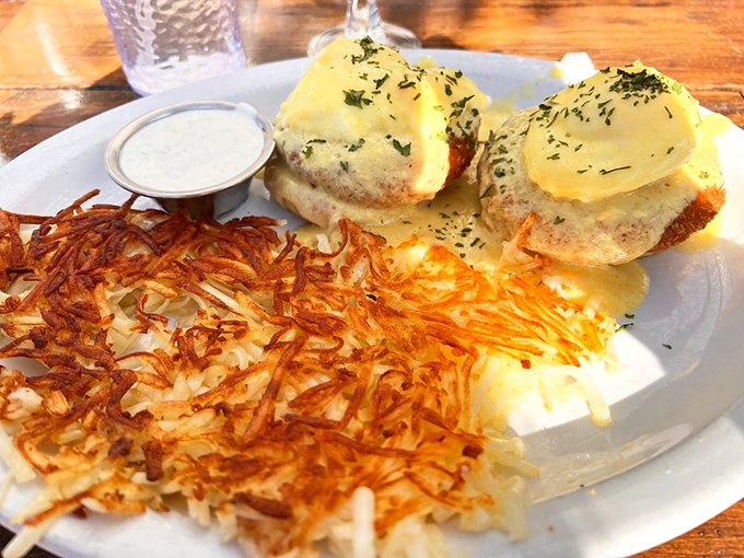 Benedict perfection: two golden thrones of English muffins supporting poached eggs in their crowning moment beneath a hollandaise kingdom.