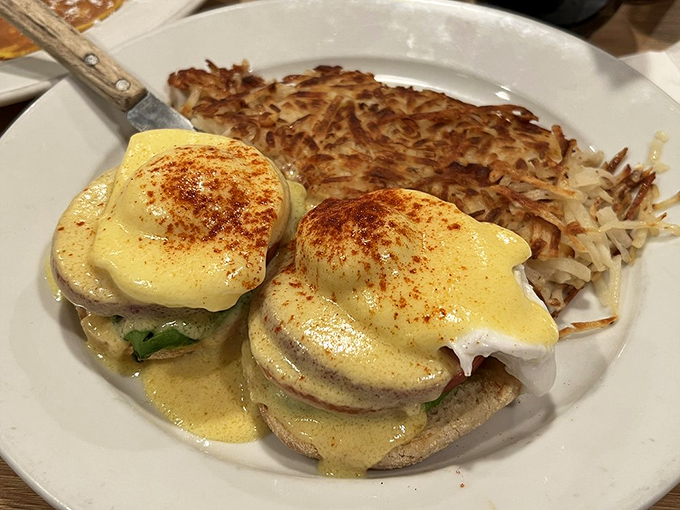 Eggs Benedict executed with textbook perfection. That hollandaise sauce is so velvety it could moonlight as a luxury bedspread.