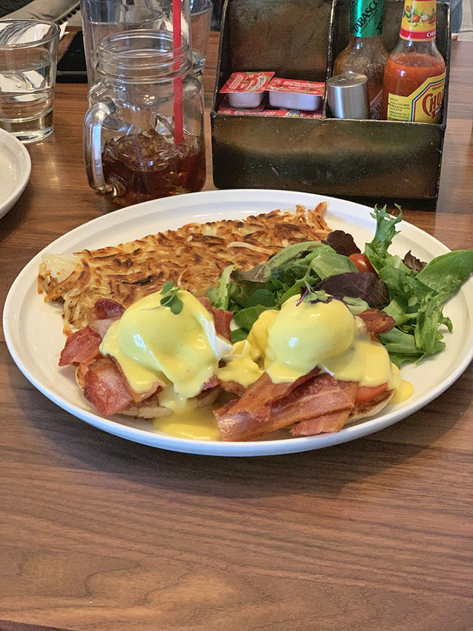 Benedict perfection&mdash;hollandaise cascading down like a yellow waterfall of buttery goodness over perfectly crisped hash browns.