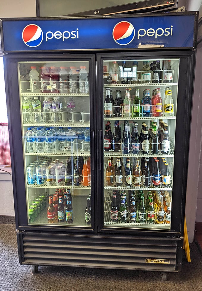 The beverage cooler &ndash; a democratic display where craft beers and humble sodas coexist peacefully. Cold drinks, warm hospitality.