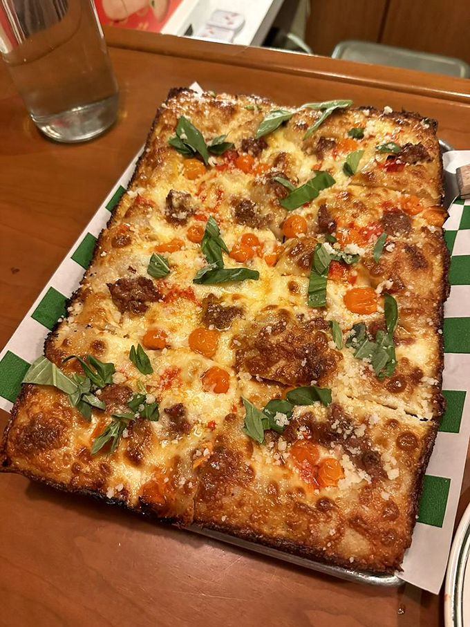 The Bianca pizza showcases what happens when tomatoes, sausage, and cheese have a party on a perfectly baked Detroit-style crust.