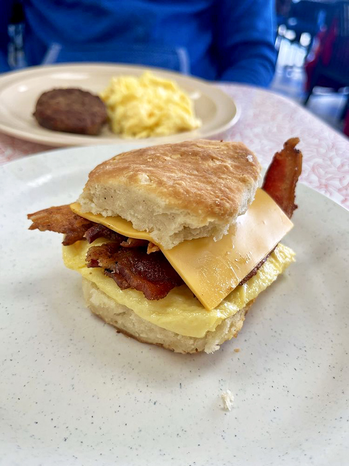 Bacon, egg, and cheese nestled in a fresh biscuit - breakfast sandwich perfection achieved.