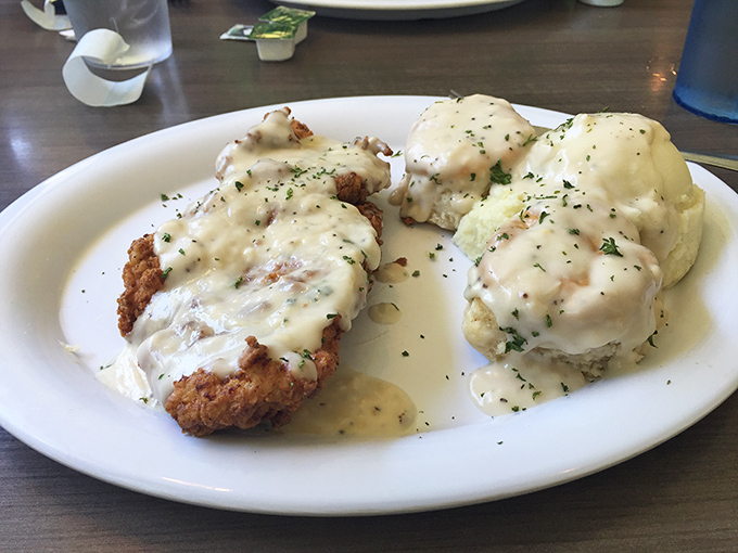 Country-fried steak smothered in creamy gravy alongside fluffy biscuits&mdash;a plate that says "you won't need dinner" in the most delicious way possible.