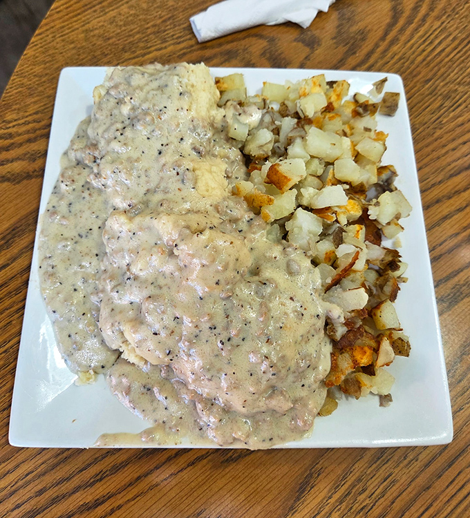 Biscuits and gravy that laugh in the face of moderation&mdash;a plate where pepper-speckled gravy blankets everything in creamy, comforting goodness.