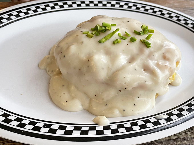 Biscuits and gravy so comforting it's like a warm hug from your favorite grandma, topped with fresh chives for that touch of sophistication.