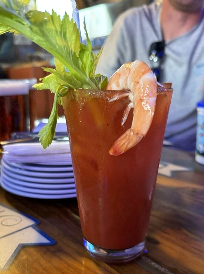 The Bloody Mary comes armed for battle with a shrimp sentinel and celery spear. It's breakfast, appetizer, and cocktail in one glorious glass.