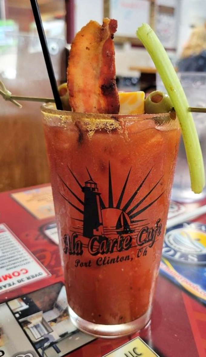 The Bloody Mary that eats like a meal. Complete with bacon, celery, and the caf&eacute;'s lighthouse logo&mdash;because drinking should never be boring.