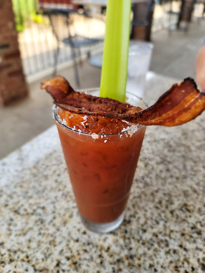 Not your average Bloody Mary—this one comes with a bacon strip so perfect it deserves its own fan club.