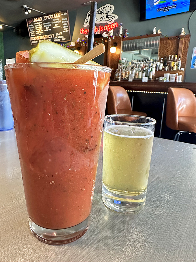 The Bloody Mary arrives like a meal in itself, accompanied by what appears to be a beer chaser—the Milwaukee handshake in liquid form.