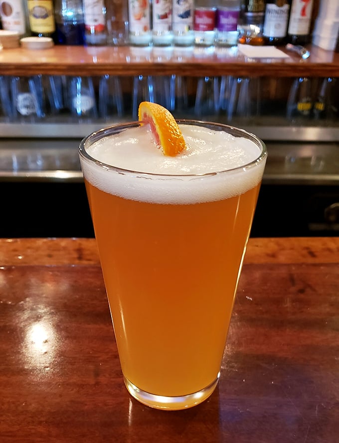 A cold craft beer with that perfect orange slice garnish &ndash; the ideal companion while deciding between stromboli and pizza (correct answer: both).