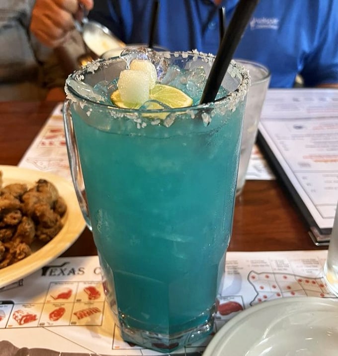 That electric blue cocktail isn't just a drink—it's vacation in a glass. The kind of beverage that says, "Yes, I'm in Florida and loving it."