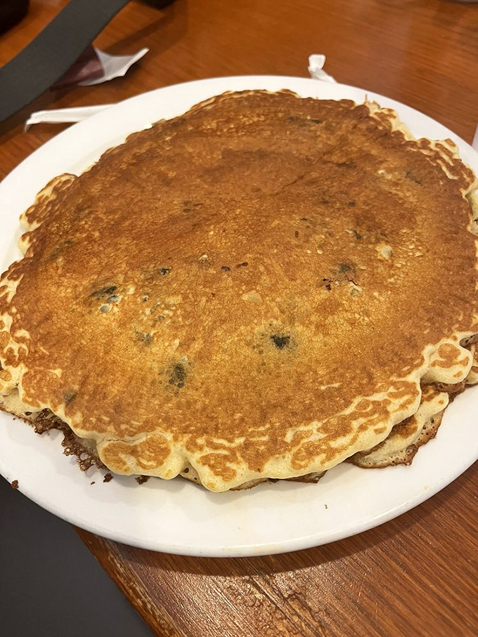 This pancake isn't just big&mdash;it's the size of your childhood dreams, perfectly golden and studded with blueberries like edible sapphires.