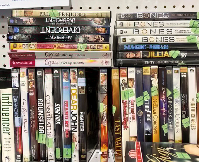 The media section: where forgotten DVDs and classic board games wait patiently for their second act. "Pride and Prejudice" meets "Bones" in this time-traveling entertainment buffet.