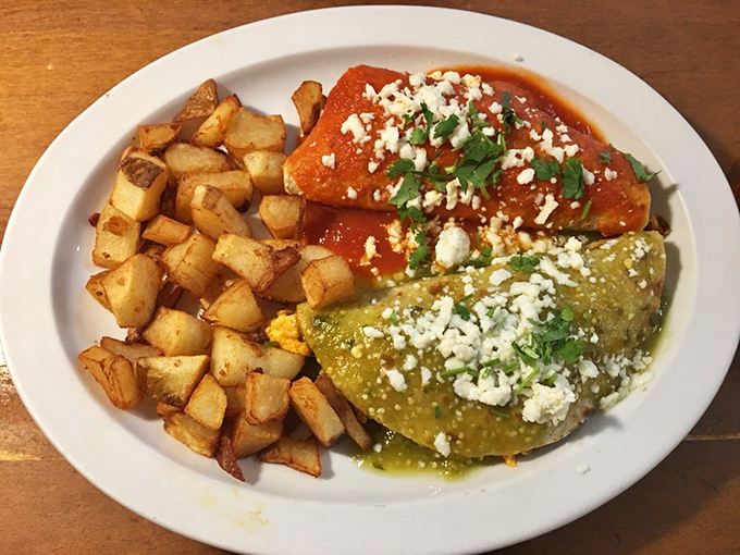 Red and green enchilada sauce create a Mexican flag of flavor, crowned with crumbled queso fresco and served with home fries that demand attention.