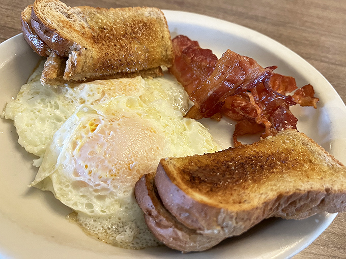 Eggs sunny-side up, bacon with that ideal crisp-to-chew ratio, and toast that actually tastes like bread. Breakfast as it should be.