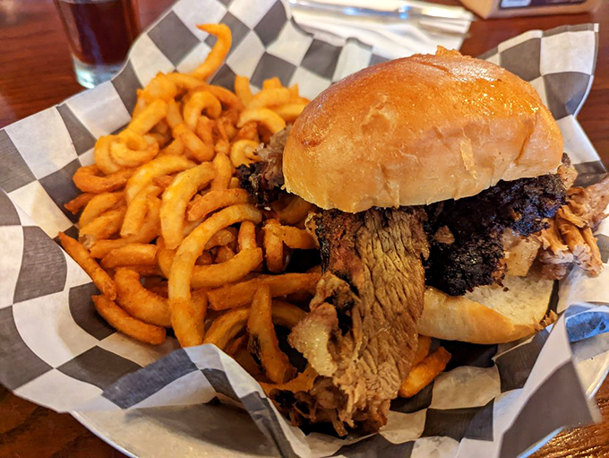 A brisket sandwich that requires both hands and your full attention. Those curly fries aren't just sides&mdash;they're golden, spiraled works of art.