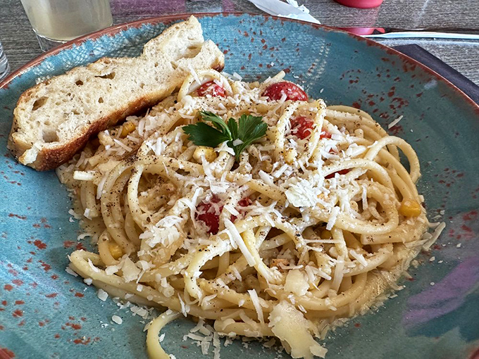 Bucatini pasta that twirls perfectly around your fork, dressed simply with cheese and tomatoes&mdash;proof that sometimes less truly is more.