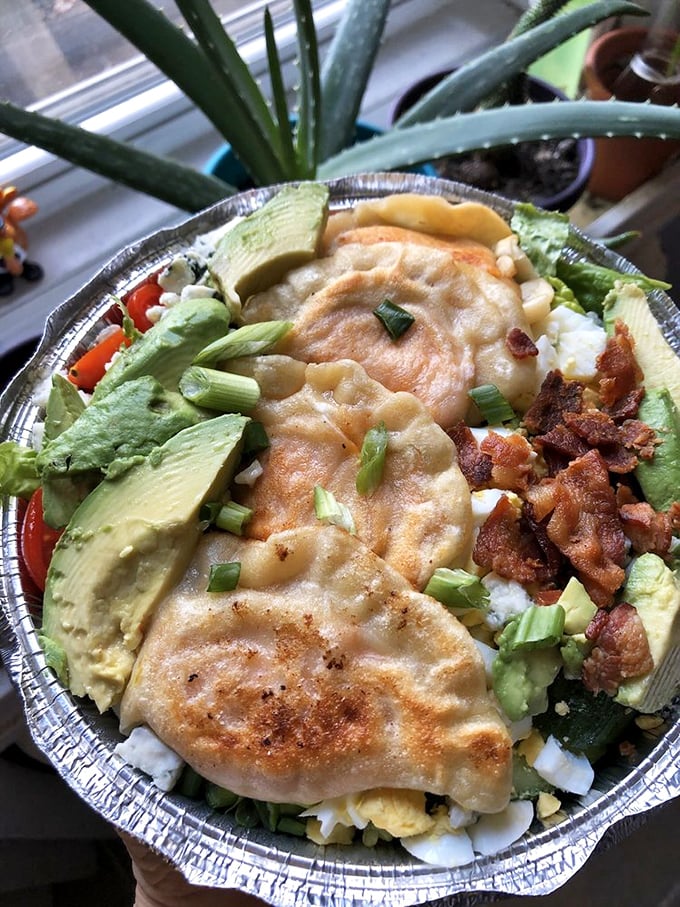 Fresh greens meet golden pierogi in this salad that somehow makes eating vegetables feel like a celebration.