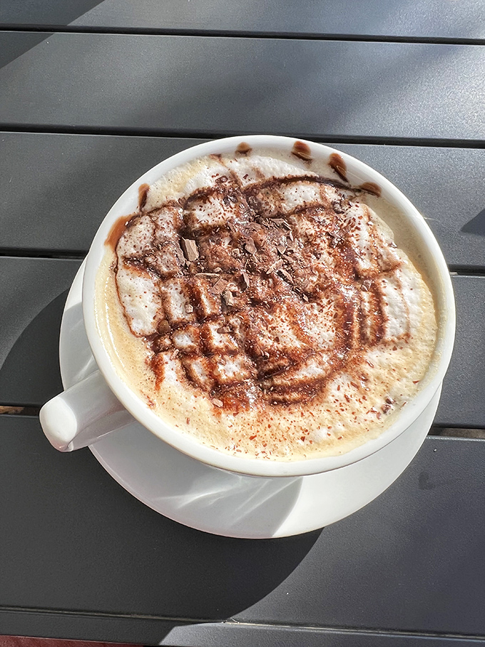 Coffee artistry that makes you pause before sipping &ndash; those chocolate drizzles aren't just decoration, they're a preview of the comfort to come.