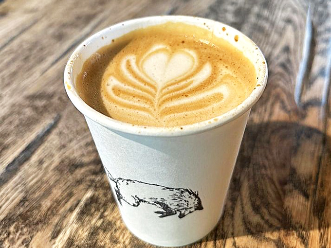 Latte art that's both ephemeral and Instagram-worthy. The fox logo cup reminds you this isn't just coffee&mdash;it's part of a carefully crafted experience.