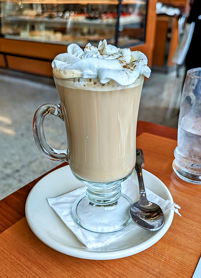 This isn't just coffee &ndash; it's a warm hug in a glass mug, topped with a cloud of whipped cream that's begging to give you a mustache.