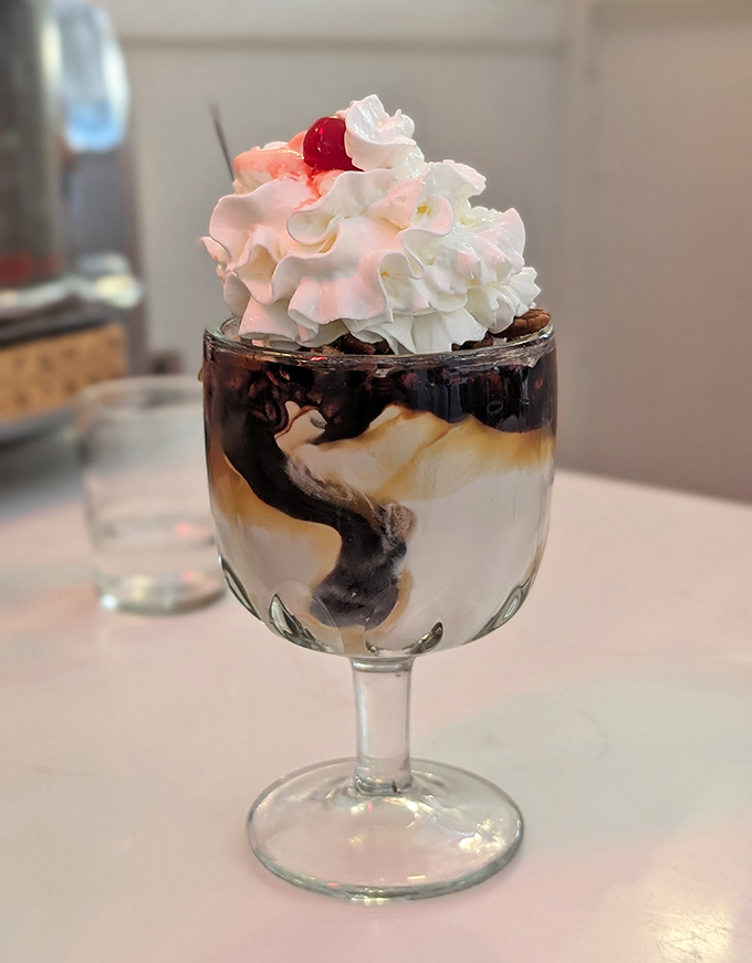 Ice cream architecture at its finest. This sundae isn't just dessert&mdash;it's a structural marvel of sweet engineering topped with a cloud of whipped cream.