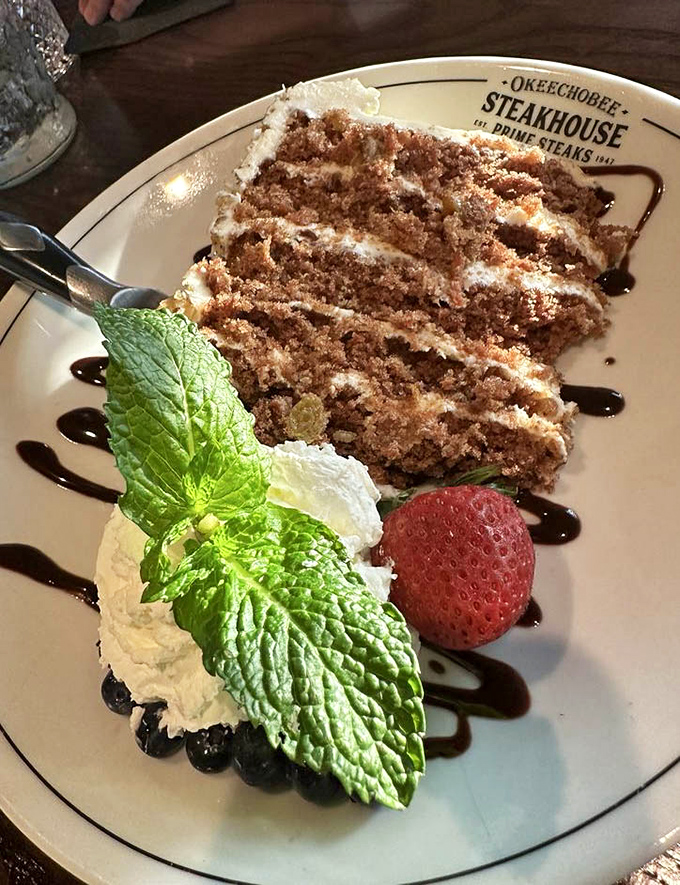 A slice of carrot cake that doesn't just end the meal but crowns it, with layers that tell a story of sweetness, spice, and everything nice.