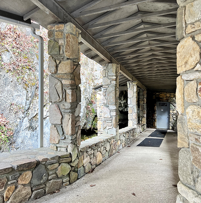 The covered entrance walkway feels like the threshold between worlds&mdash;one last glimpse of sunlight before entering the mountain's embrace.