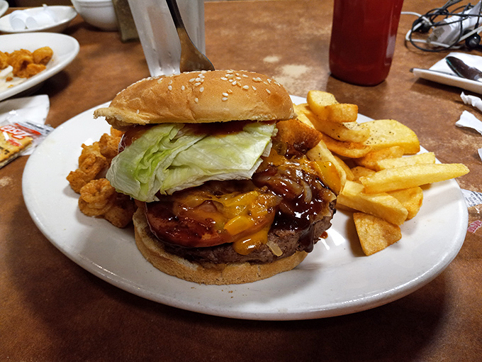 This burger isn't just a meal, it's an architectural achievement &ndash; layers of flavor stacked between buns with fries standing guard.