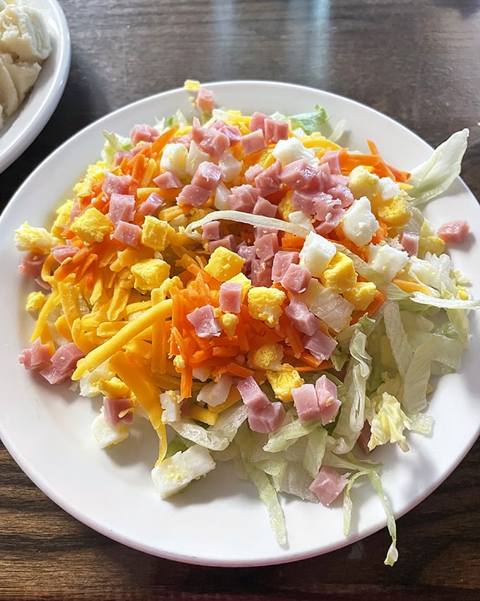 A chef's salad that doesn't apologize for its abundance of ham, cheese and egg – because vegetables need protein companions too.